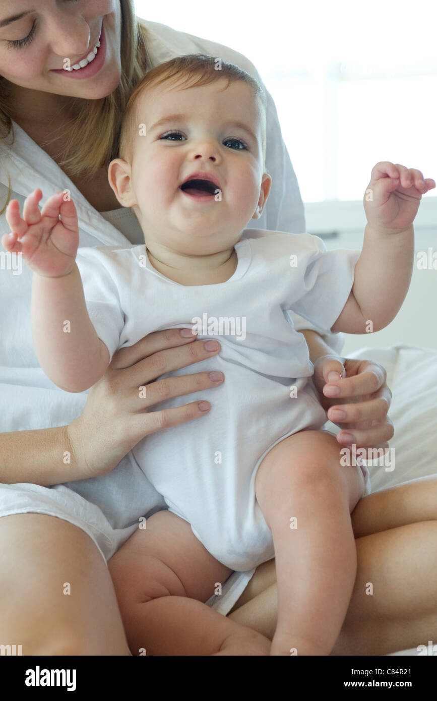 Baby sitting on mother's lap, laughing Stock Photo - Alamy Baby sitting on mother's lap, laughing Stock Photo - Alamy