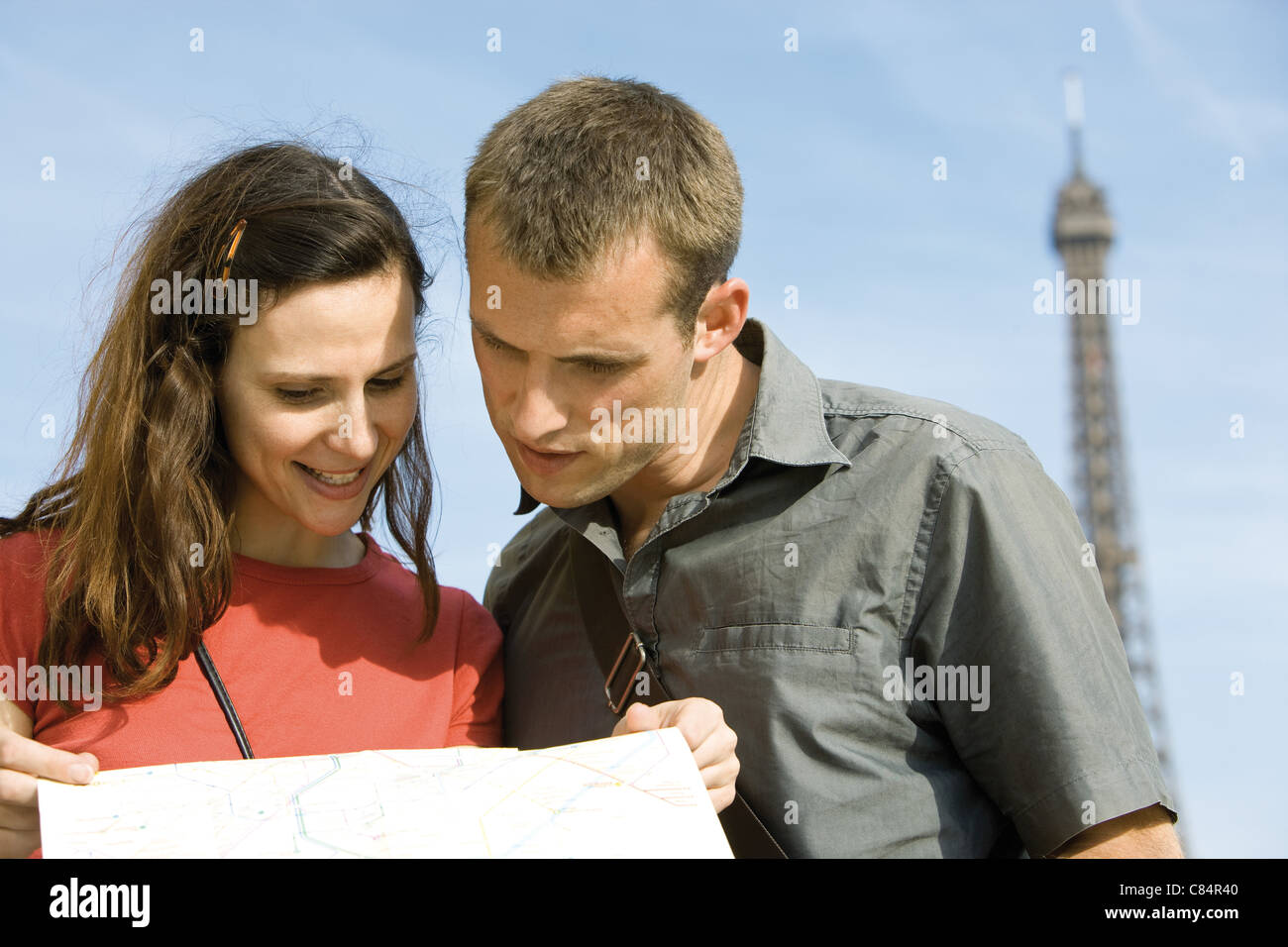 Tourists looking at map Stock Photo - Alamy