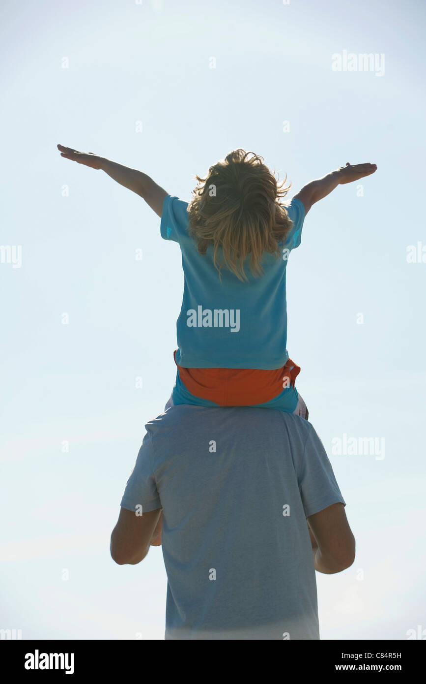 Boy riding on father's shoulders, rear view Stock Photo - Alamy