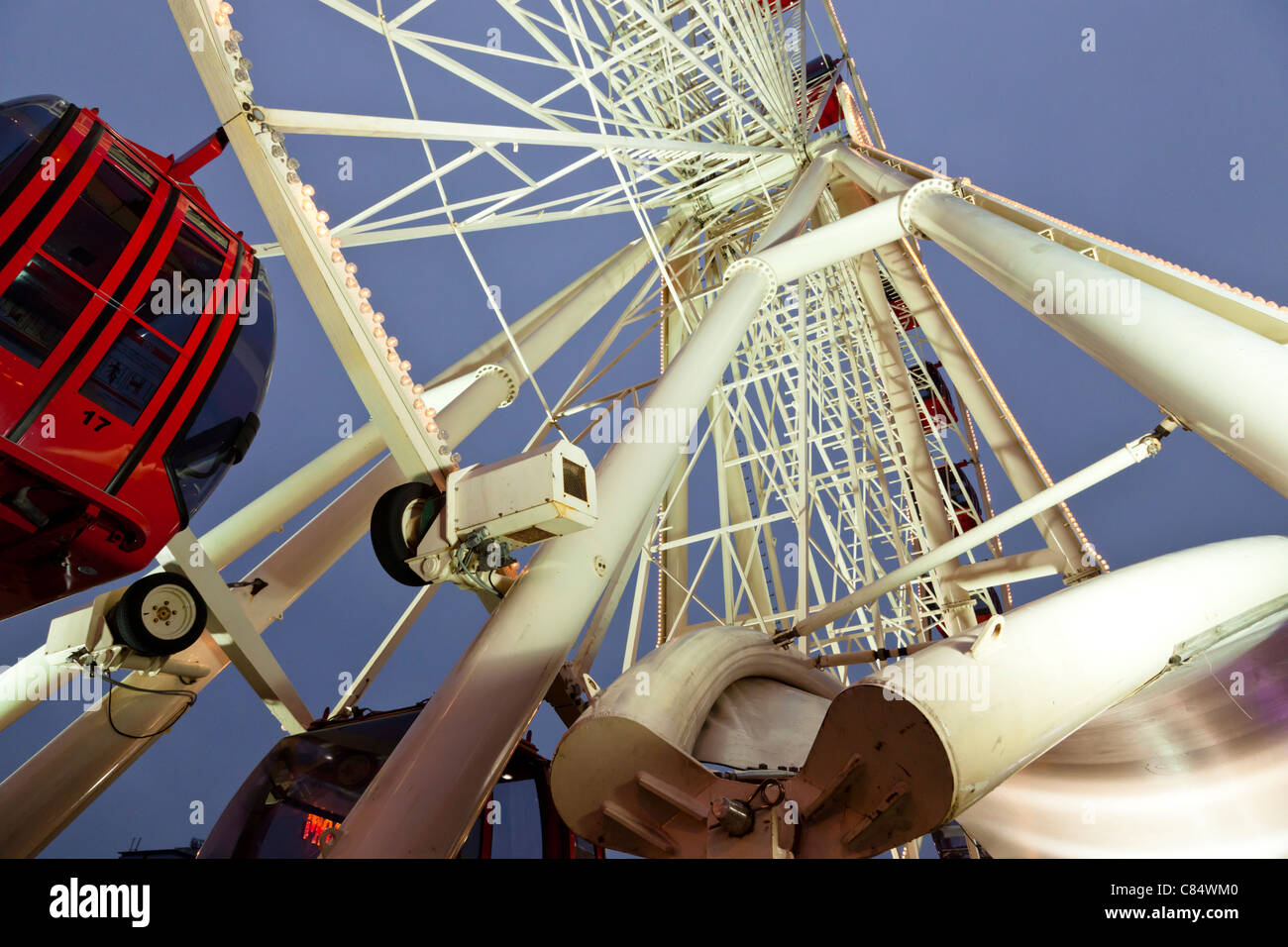 Fairground ride at night. Big wheel or ferris wheel seen from below ...