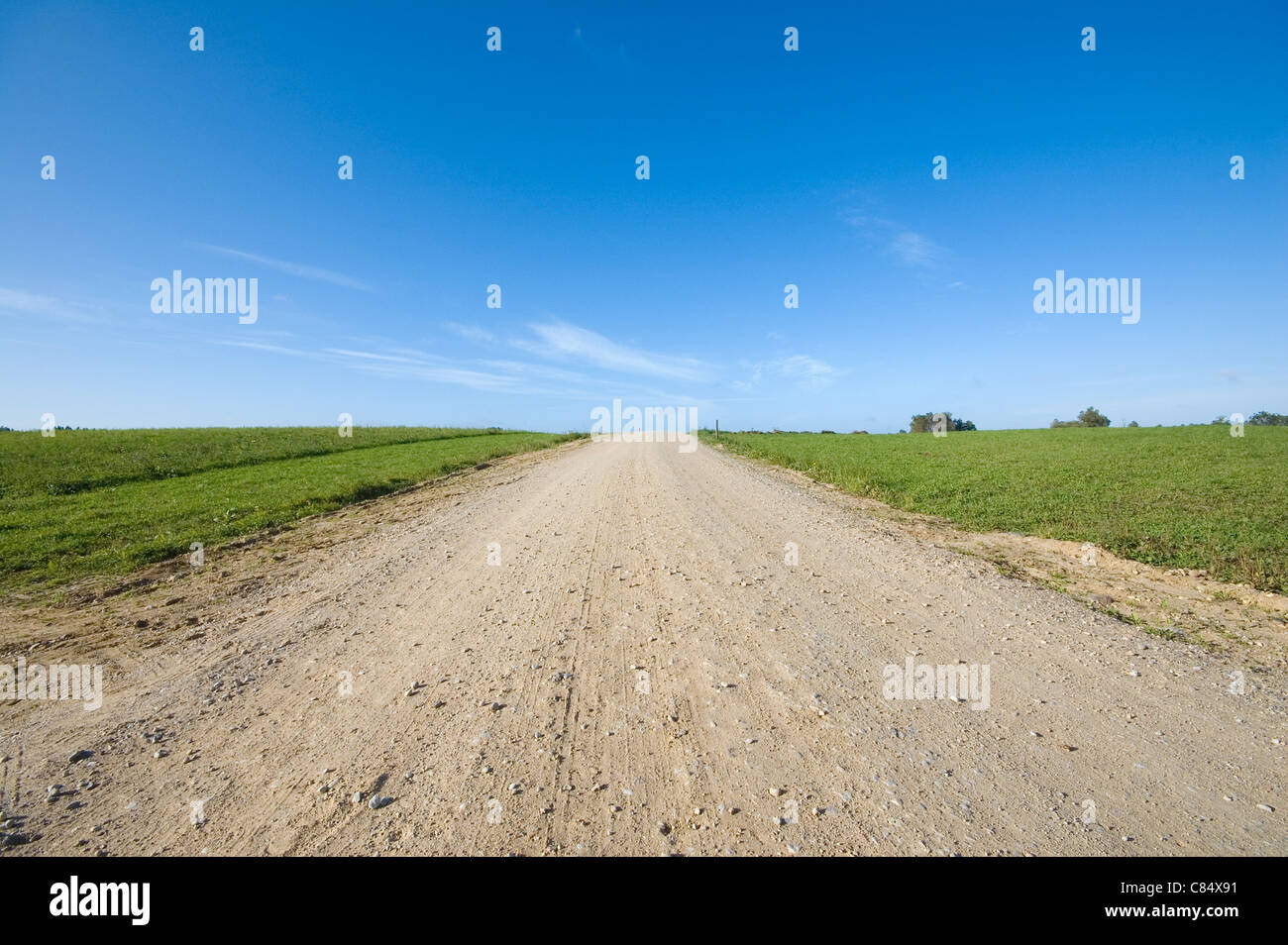 Country road running through field Stock Photo - Alamy
