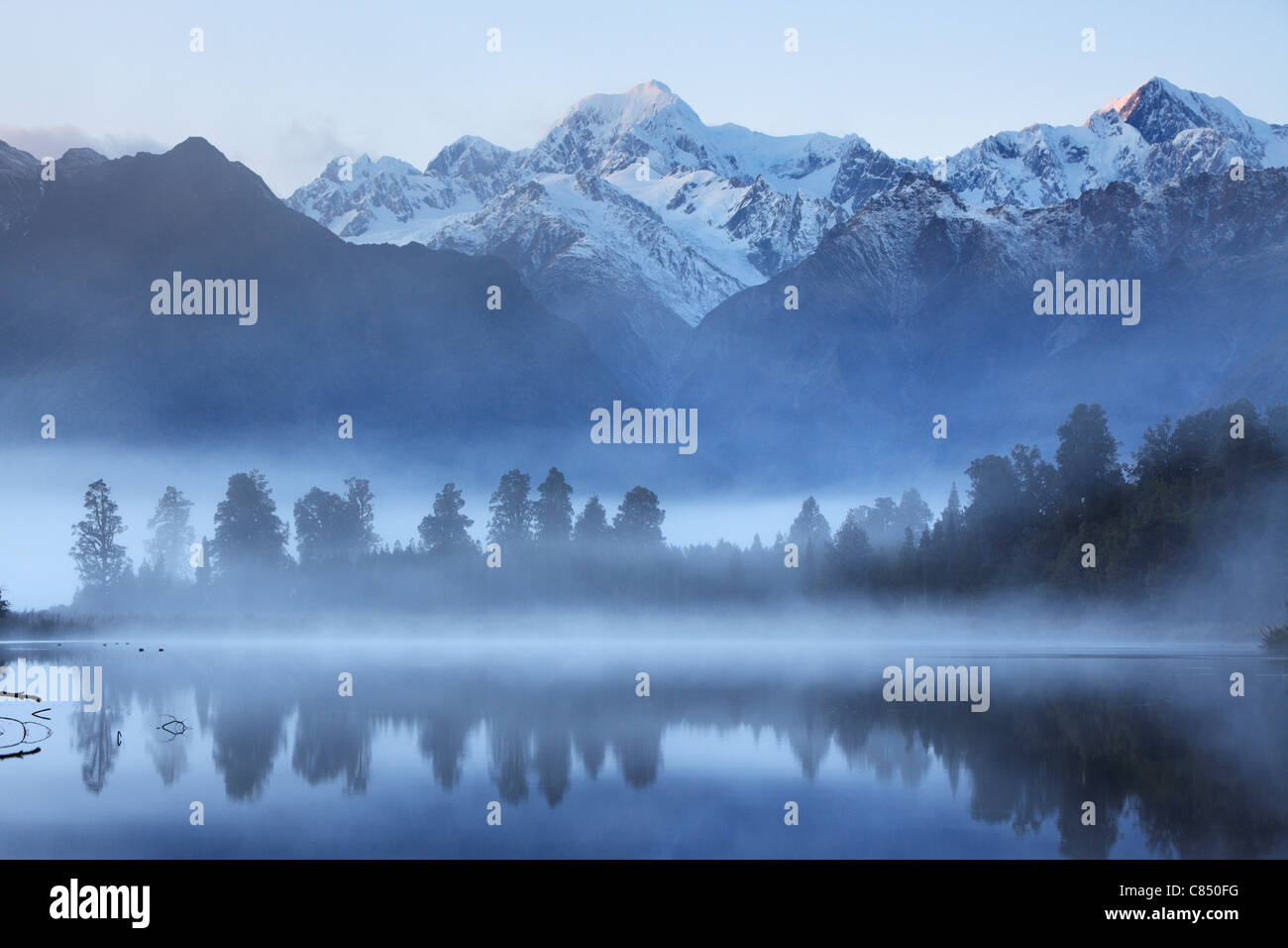 Reflection of Mt Cook (Aoraki) and Mt Tasman on Lake Matheson near Fox ...