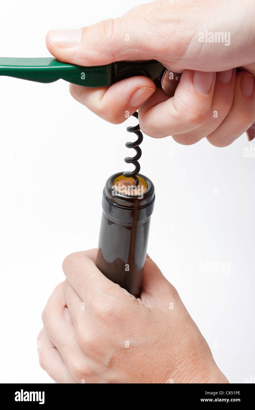 Hands uncorking a bottle of wine Stock Photo - Alamy