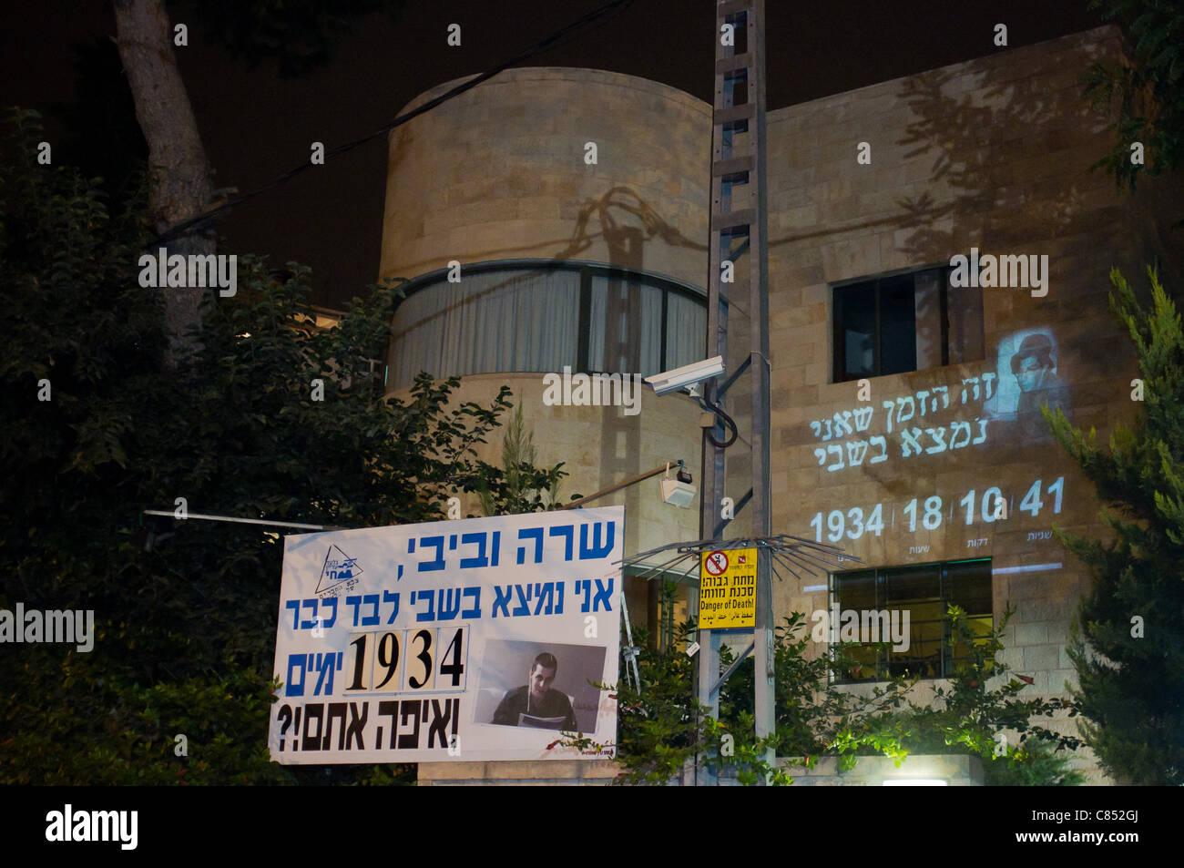 A sign and projection on a building across from the Shalit family ...
