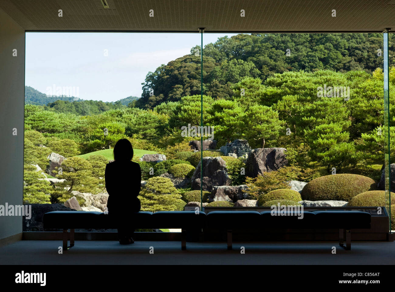 A visitor looks out at part of the Japanese garden at the Adachi Museum ...