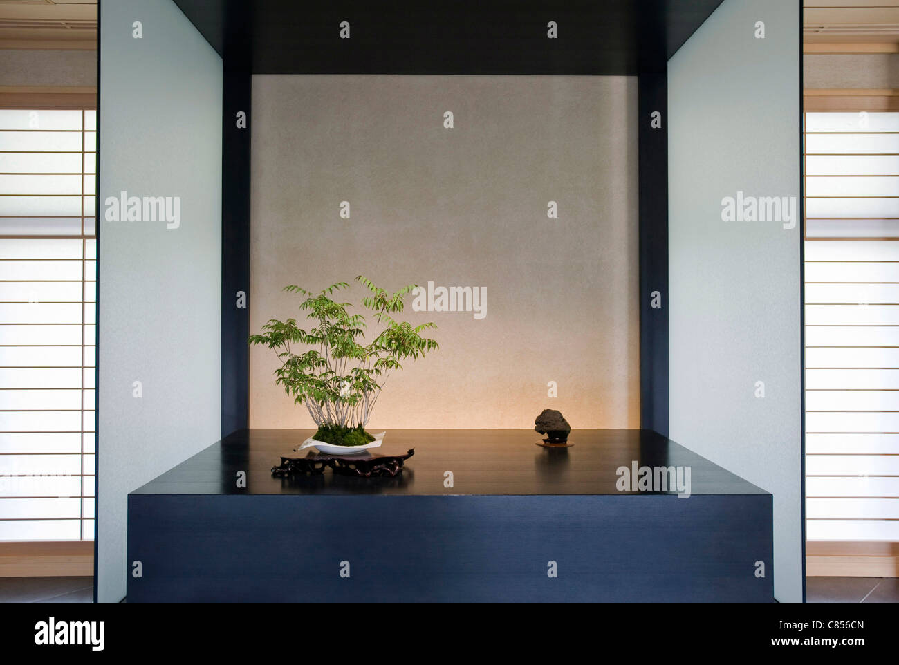 A suiseki stone shaped like a rural Japanese cottage is on display next ...