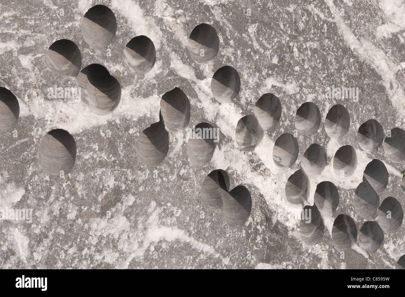 Abstract pattern caused by drill holes in a gray schist rock Stock ...