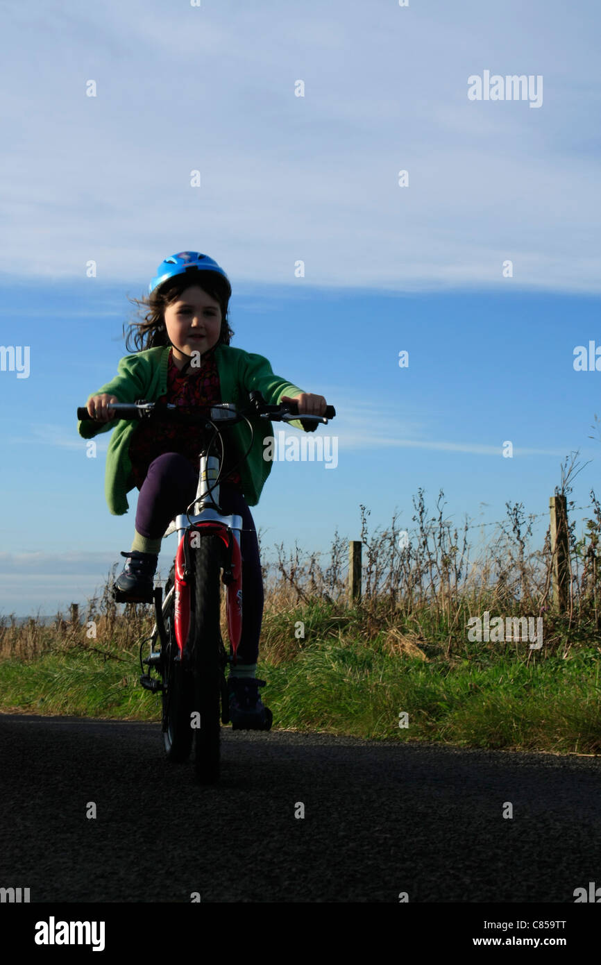 Young girl cycling Stock Photo - Alamy