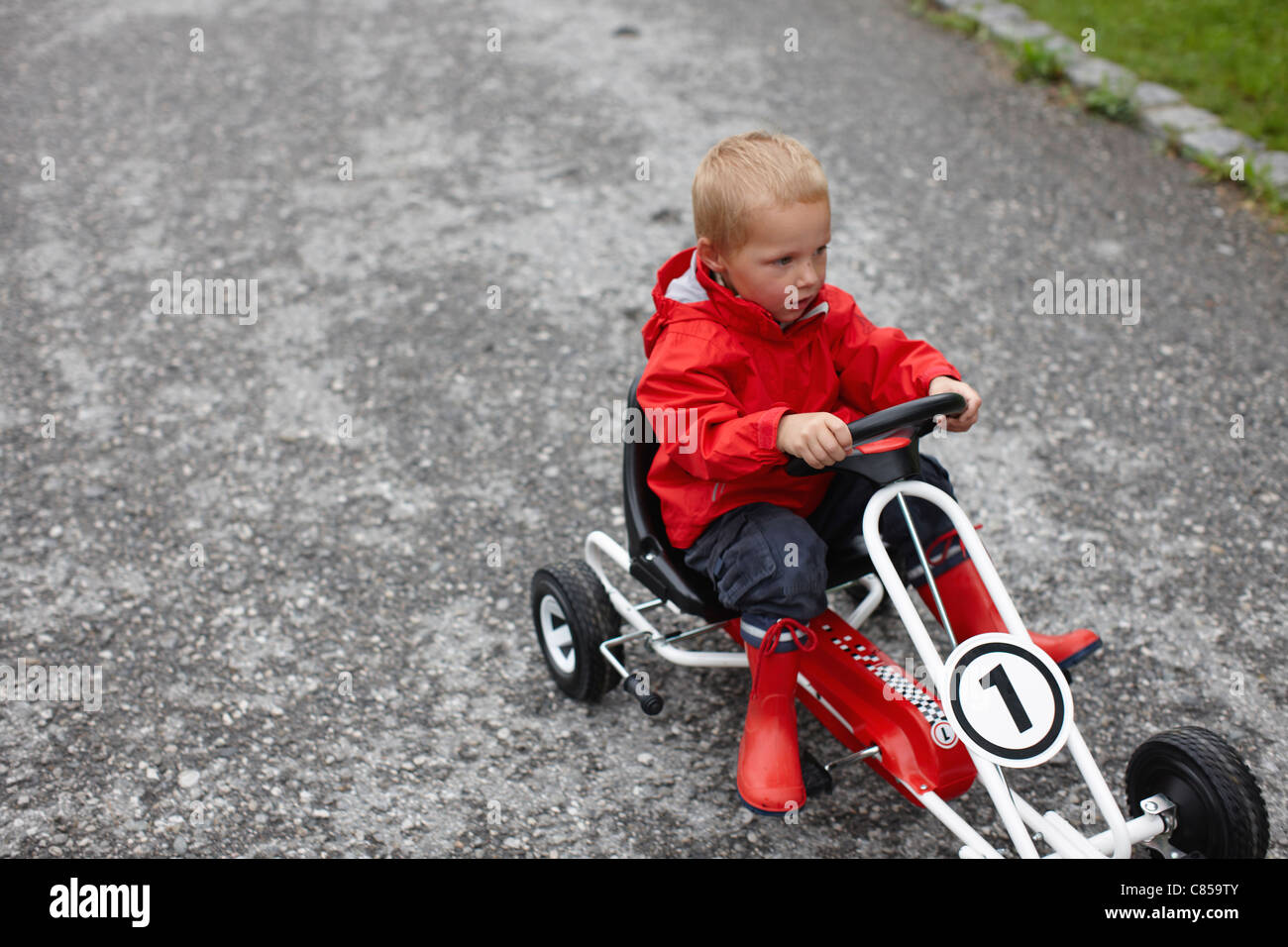 Toddler boy riding go-cart Stock Photo - Alamy