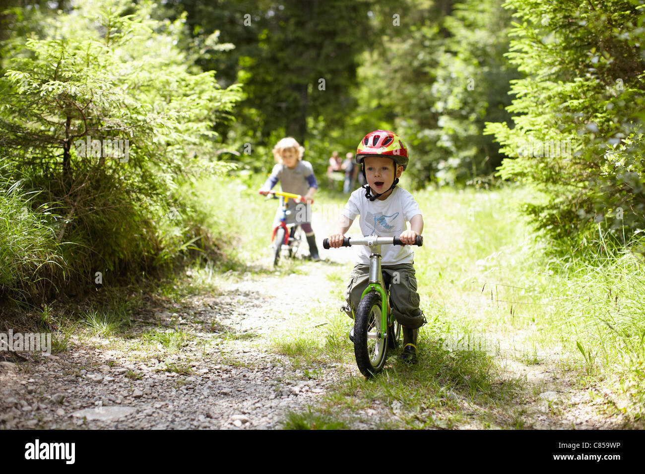 Toddler boy riding bike on dirt path Stock Photo - Alamy