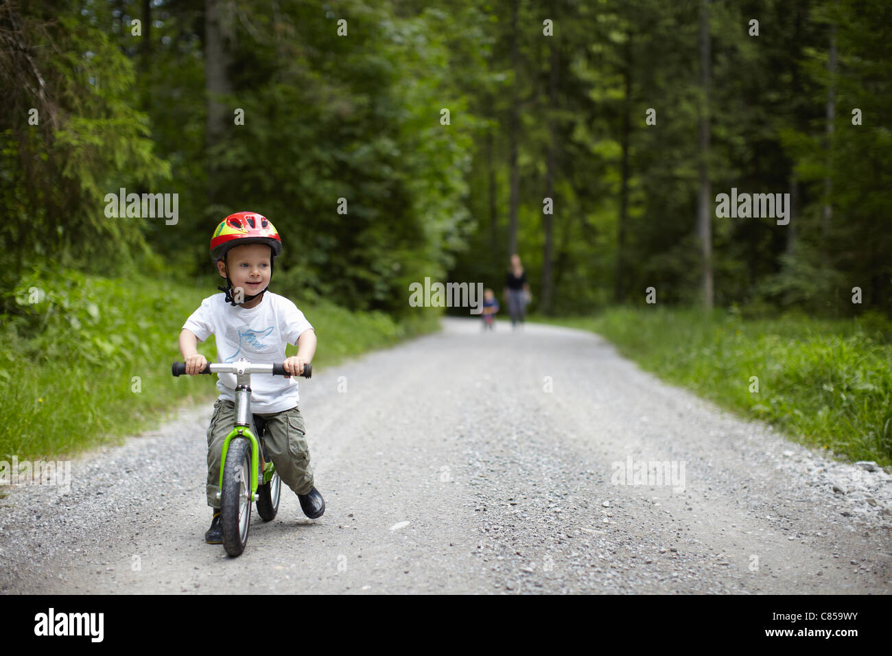 Toddler boy riding bike on dirt path Stock Photo - Alamy