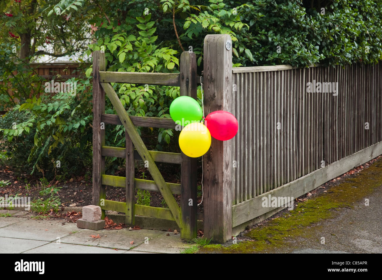 Balloons - at an entrance gate to a home in the UK. They indicate that ...