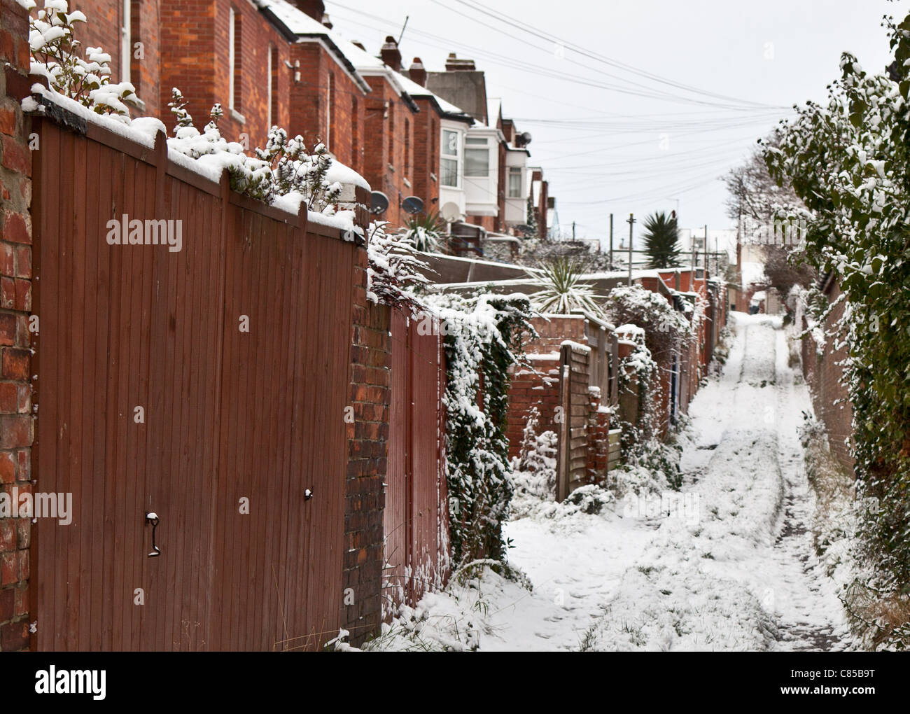 Snow up an alley on a early morning walk Stock Photo - Alamy