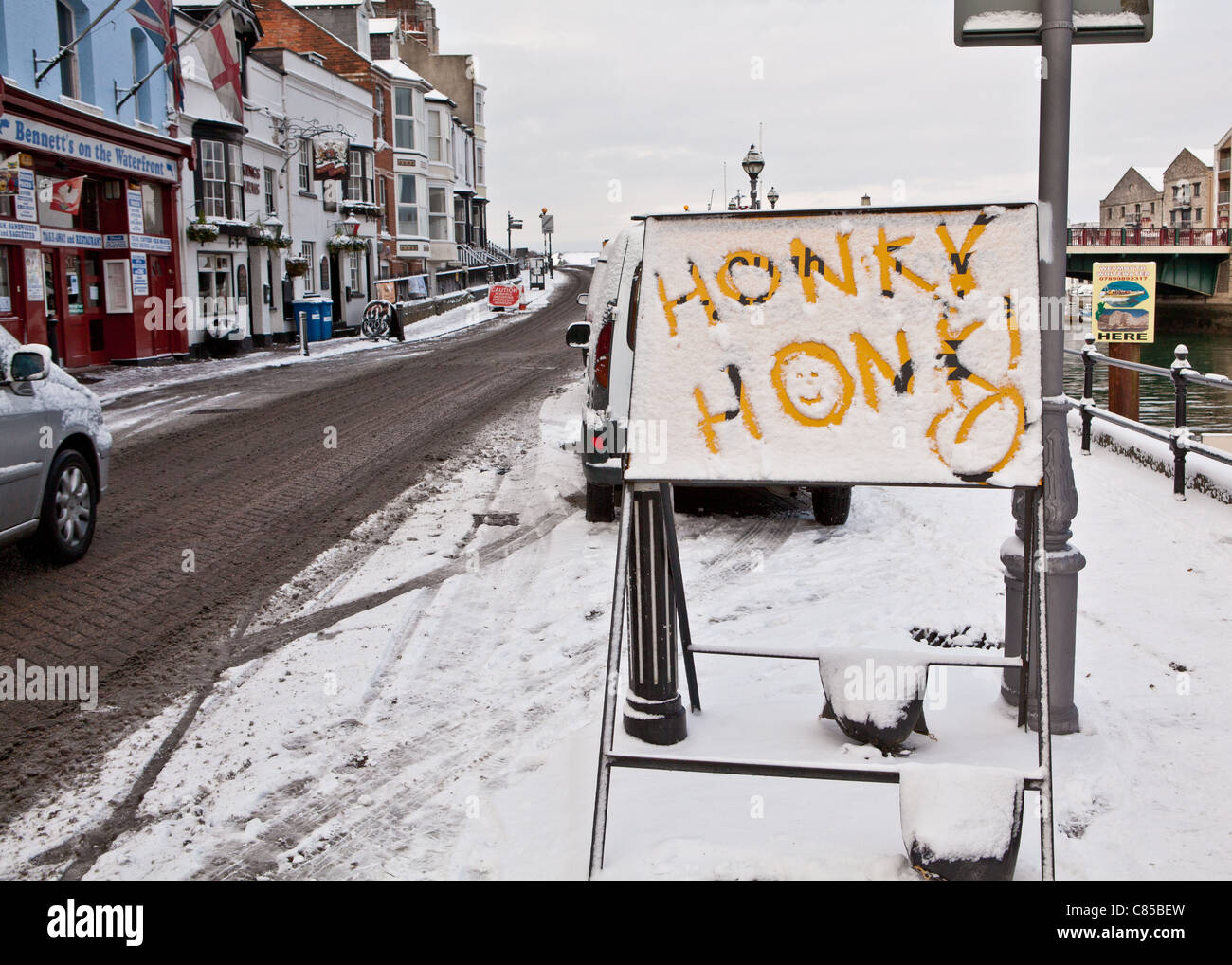 Honk honk written in the snow on the temporary sign next to the road on ...