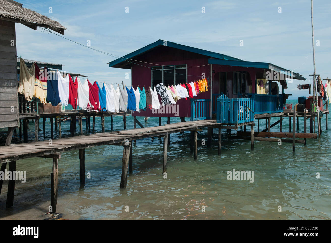 clothes hanging to dry in sea gypsy village near Mabul Island, Borneo ...