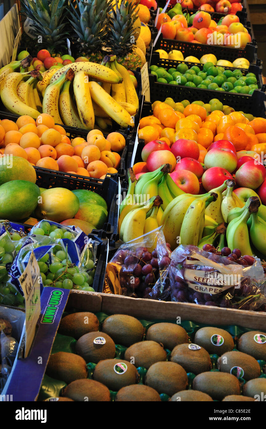 A display of various fruits on a market stall including bananas and ...
