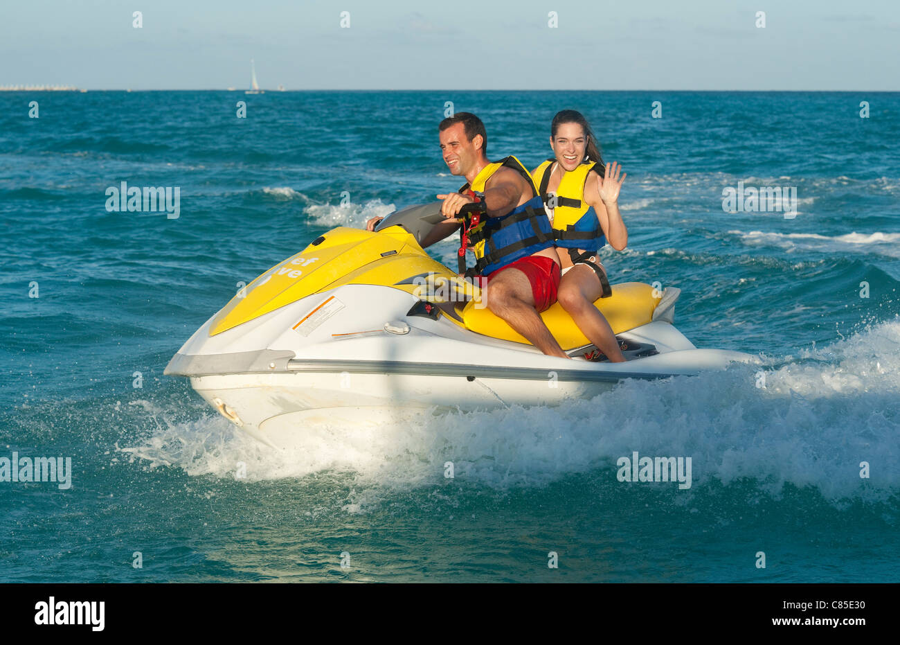 Couple on Personal Watercraft Stock Photo - Alamy