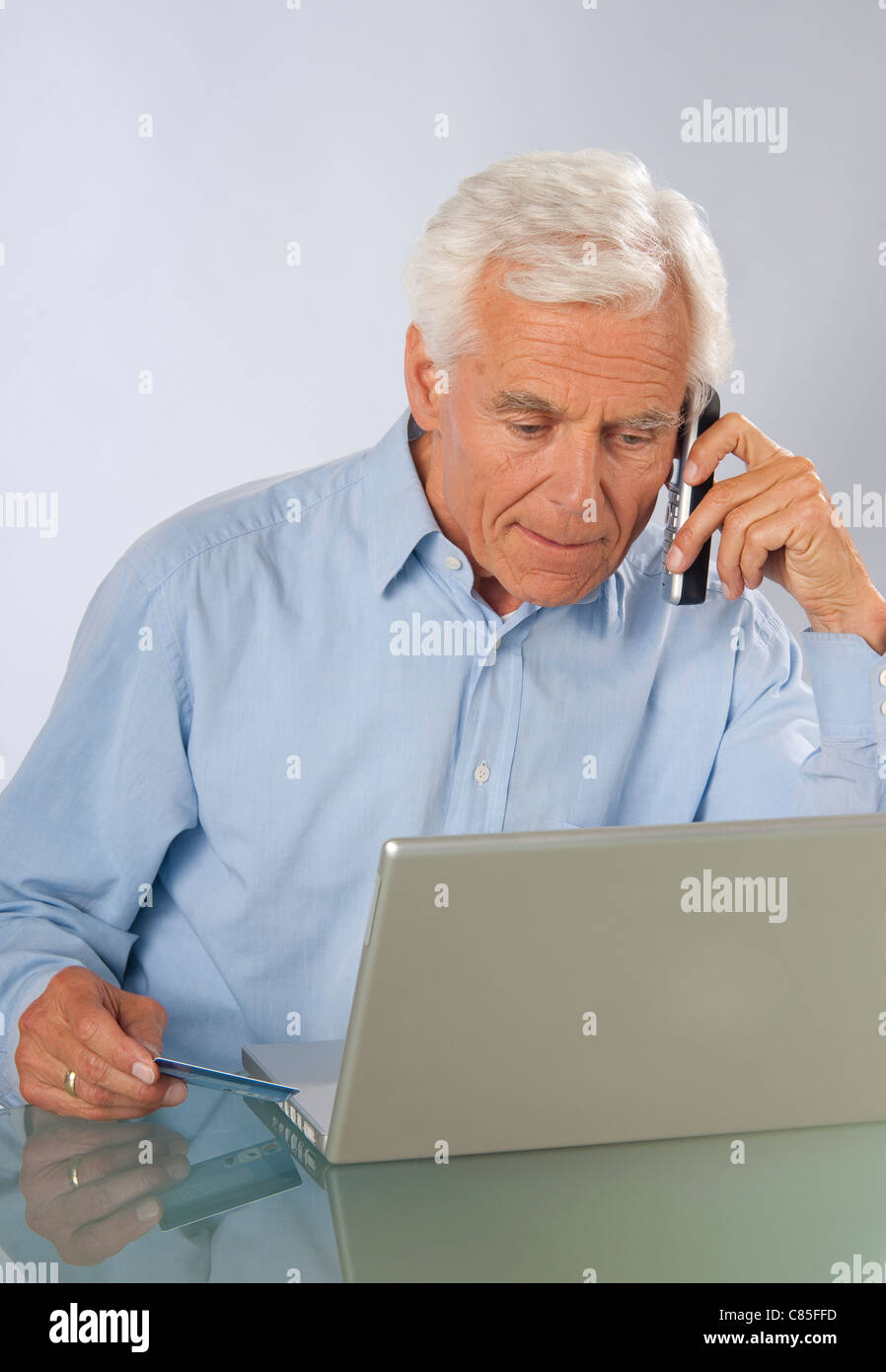 Man using Laptop and Cordless Phone Stock Photo - Alamy