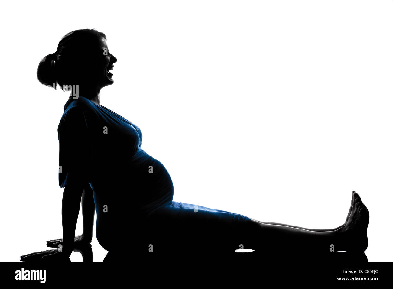 beautiful caucasian pregnant woman laughing happy in silhouette on ...