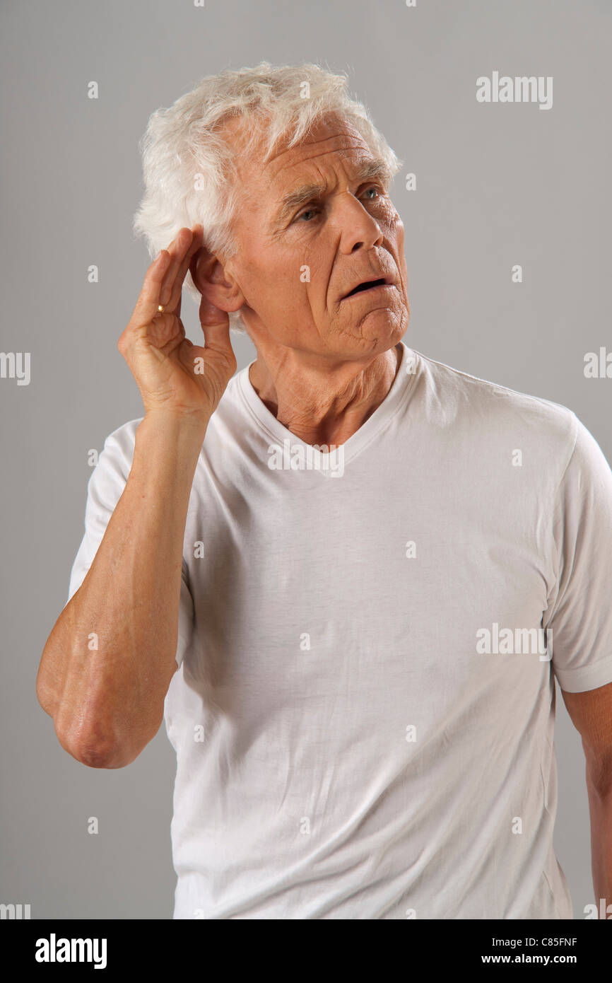 Man with Hand to Ear Stock Photo - Alamy