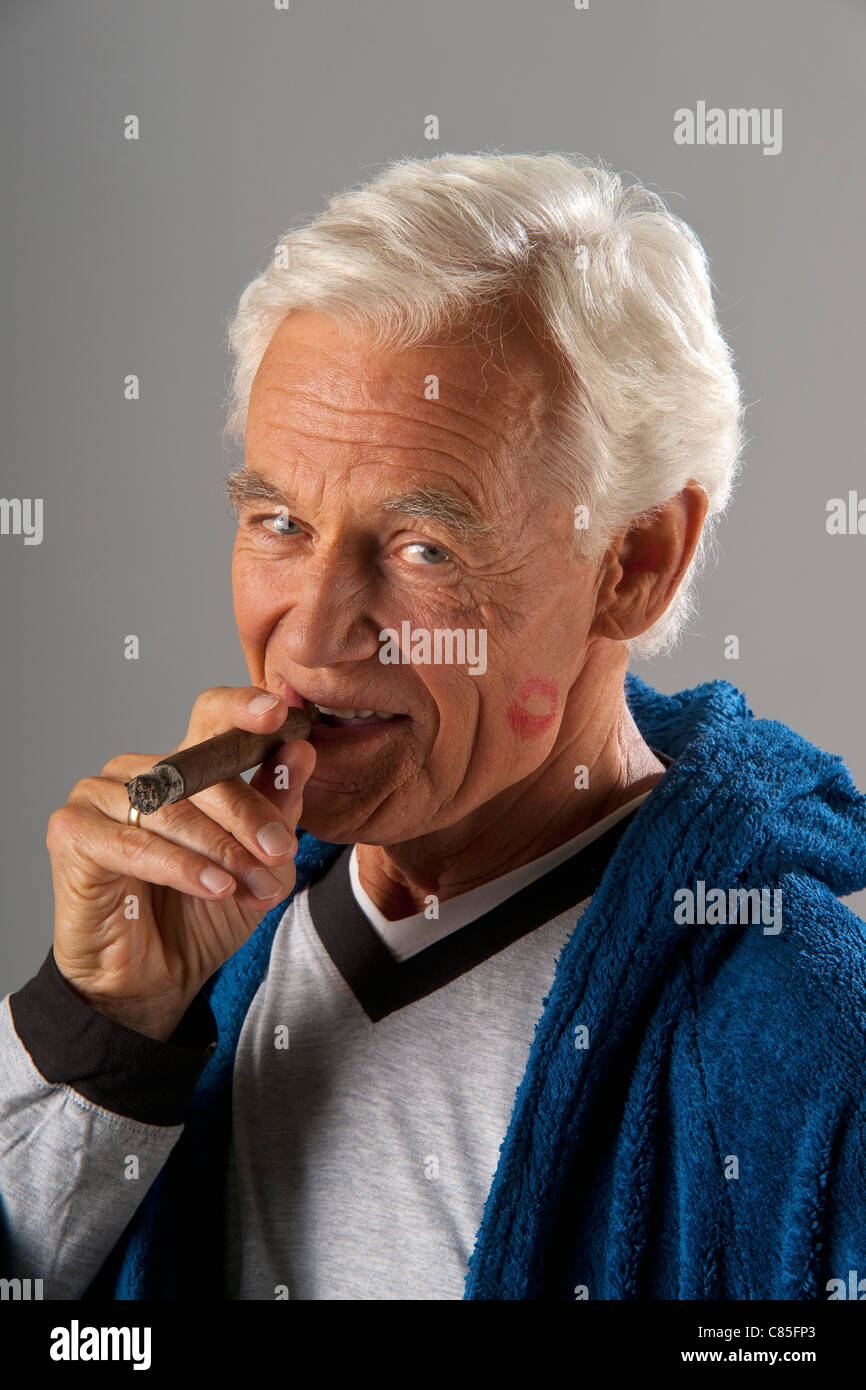 Man Smoking Cigar with Lipstick Kiss on Cheek Stock Photo - Alamy
