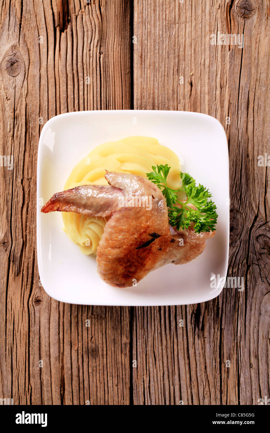 Dish of roasted chicken wing and mashed potato Stock Photo - Alamy