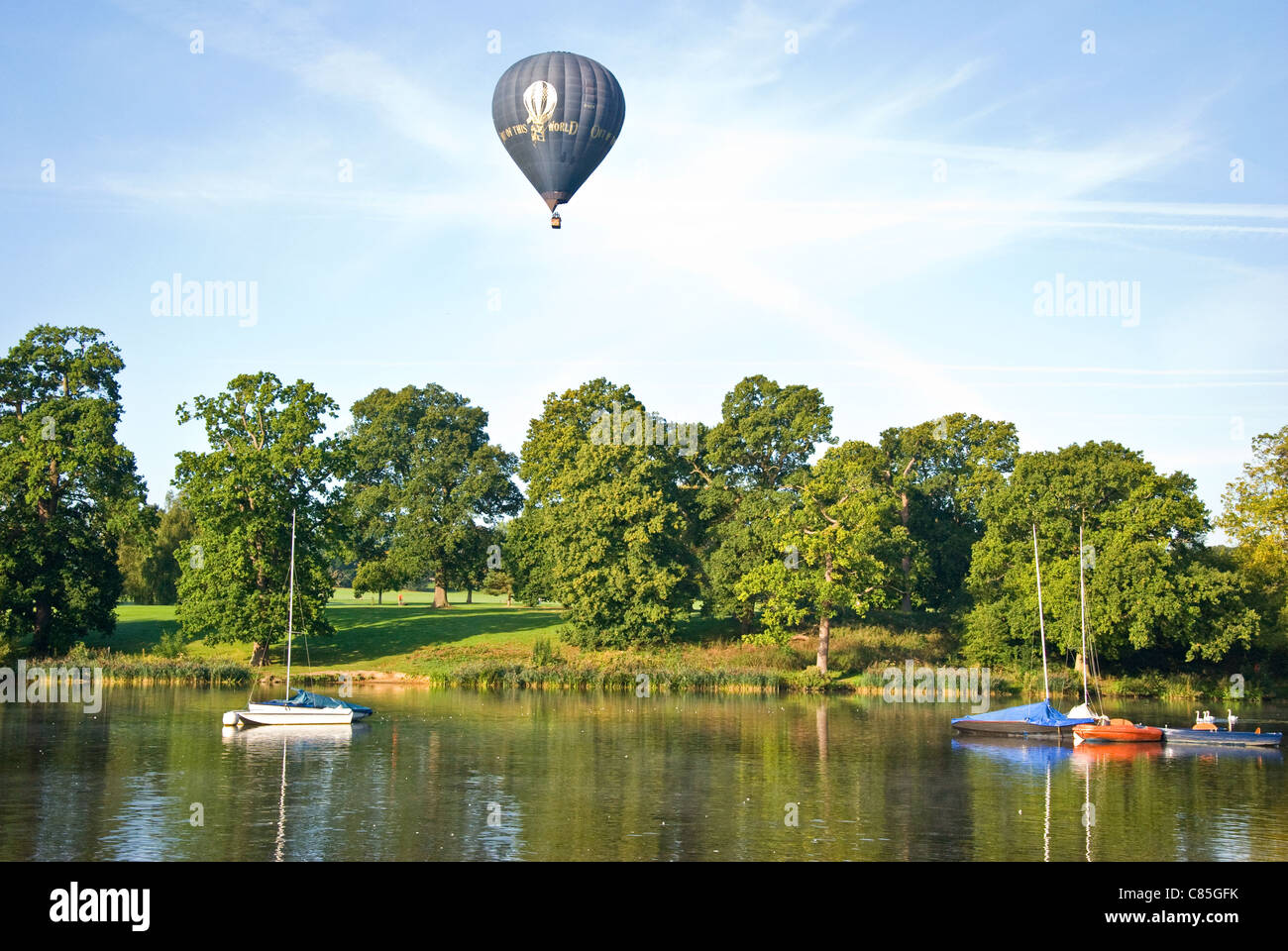 Hot air balloon over a lake Stock Photo - Alamy