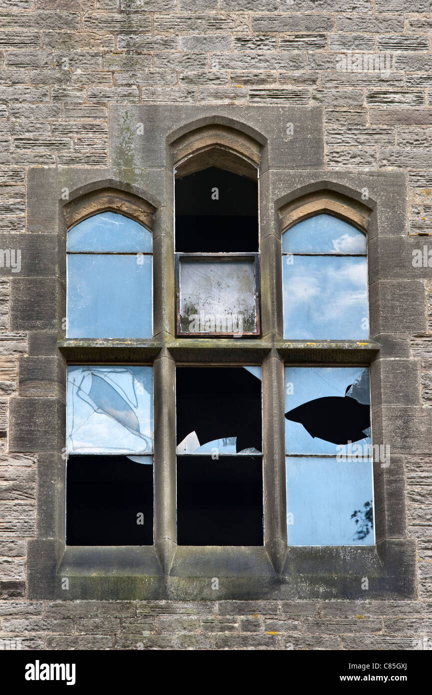 Windows broken by vandals in an empty and abandoned Victorian building ...