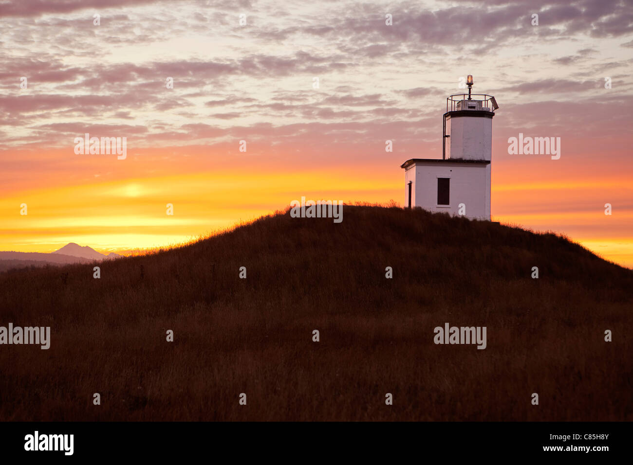 Lighthouse At Sunrise Stock Photo - Alamy