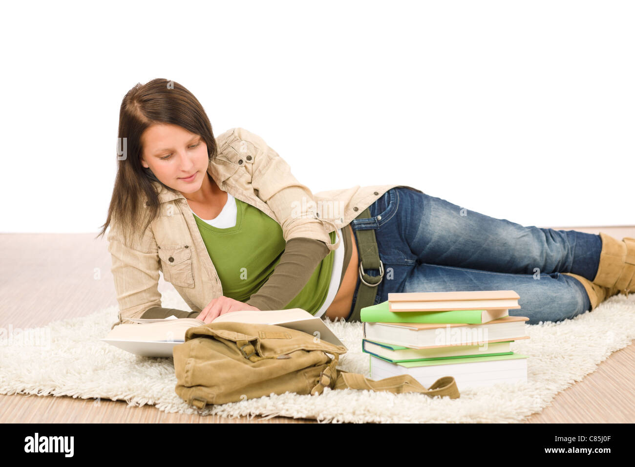 Student female teenager read homework with book on white background ...