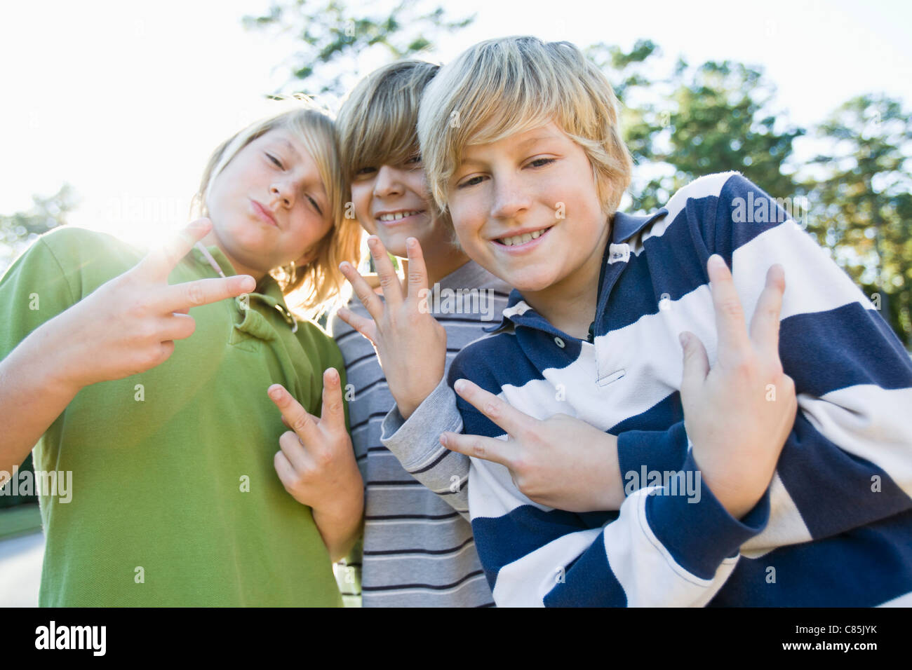 Boys Making Hand Gestures Stock Photo - Alamy