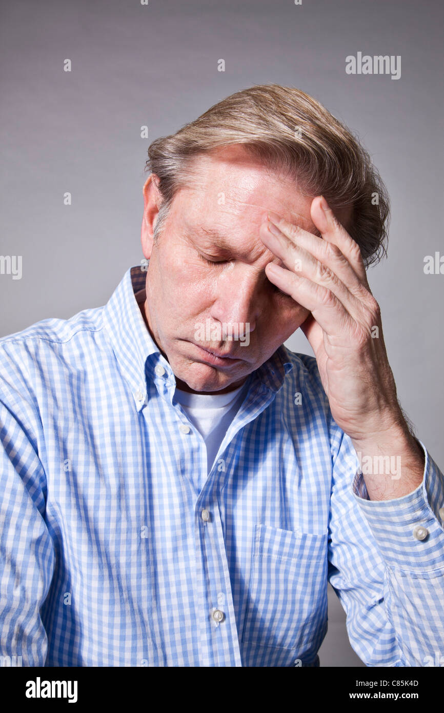 Portrait of Man with Hand on Head Stock Photo - Alamy