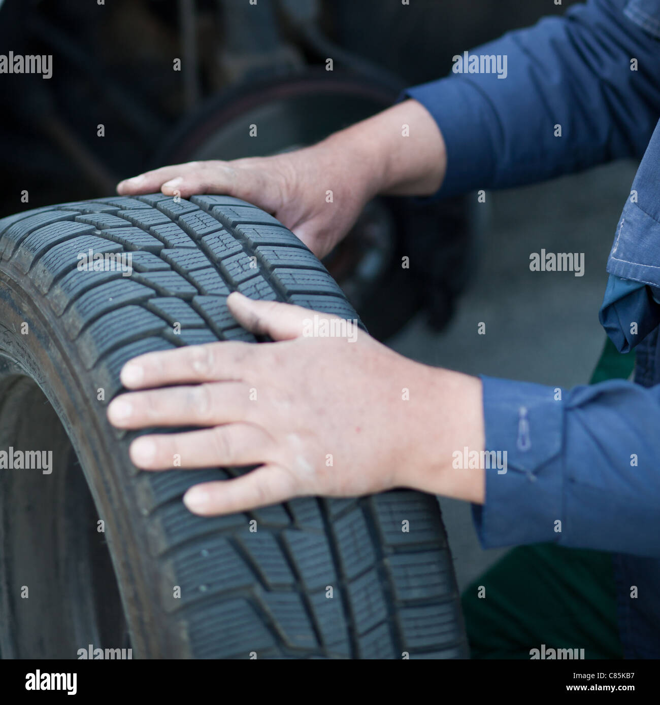 mechanic changing a wheel of a modern car (color toned image Stock ...