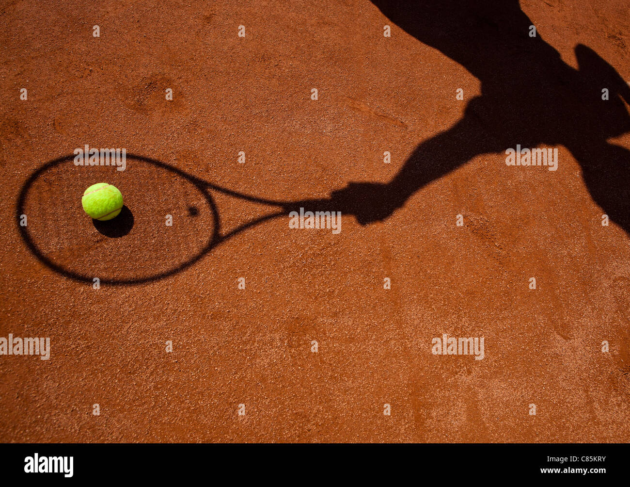 shadow of a tennis player in action on a tennis court Stock Photo - Alamy