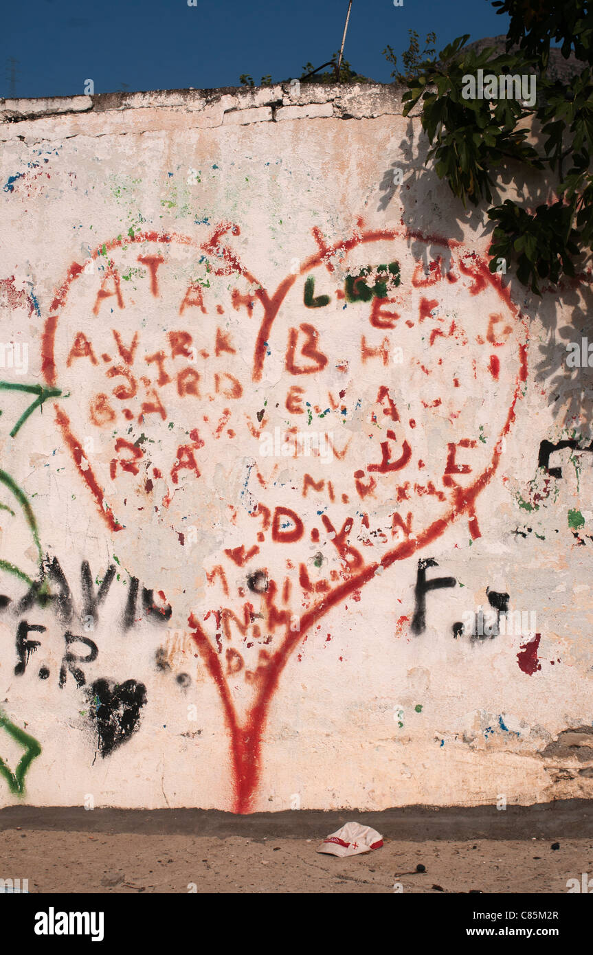 Milot village. Love heart with graffiti initials on school wall Stock ...