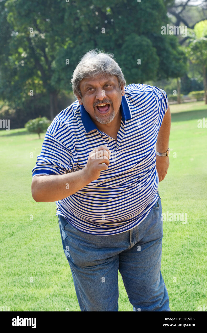 Older man trying to catch up Stock Photo - Alamy
