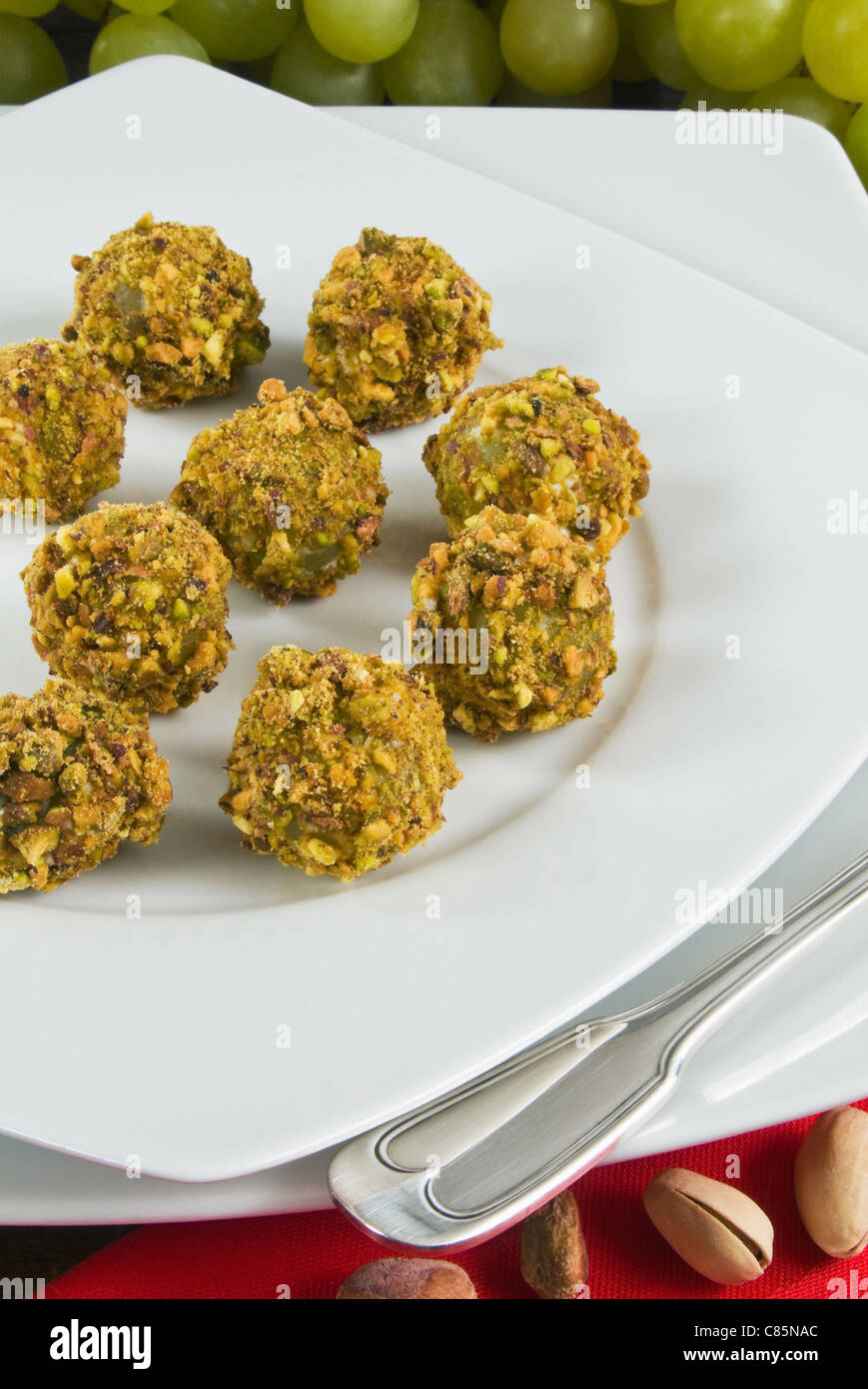 Balls of grapes with cheese and chopped pistachios Stock Photo - Alamy