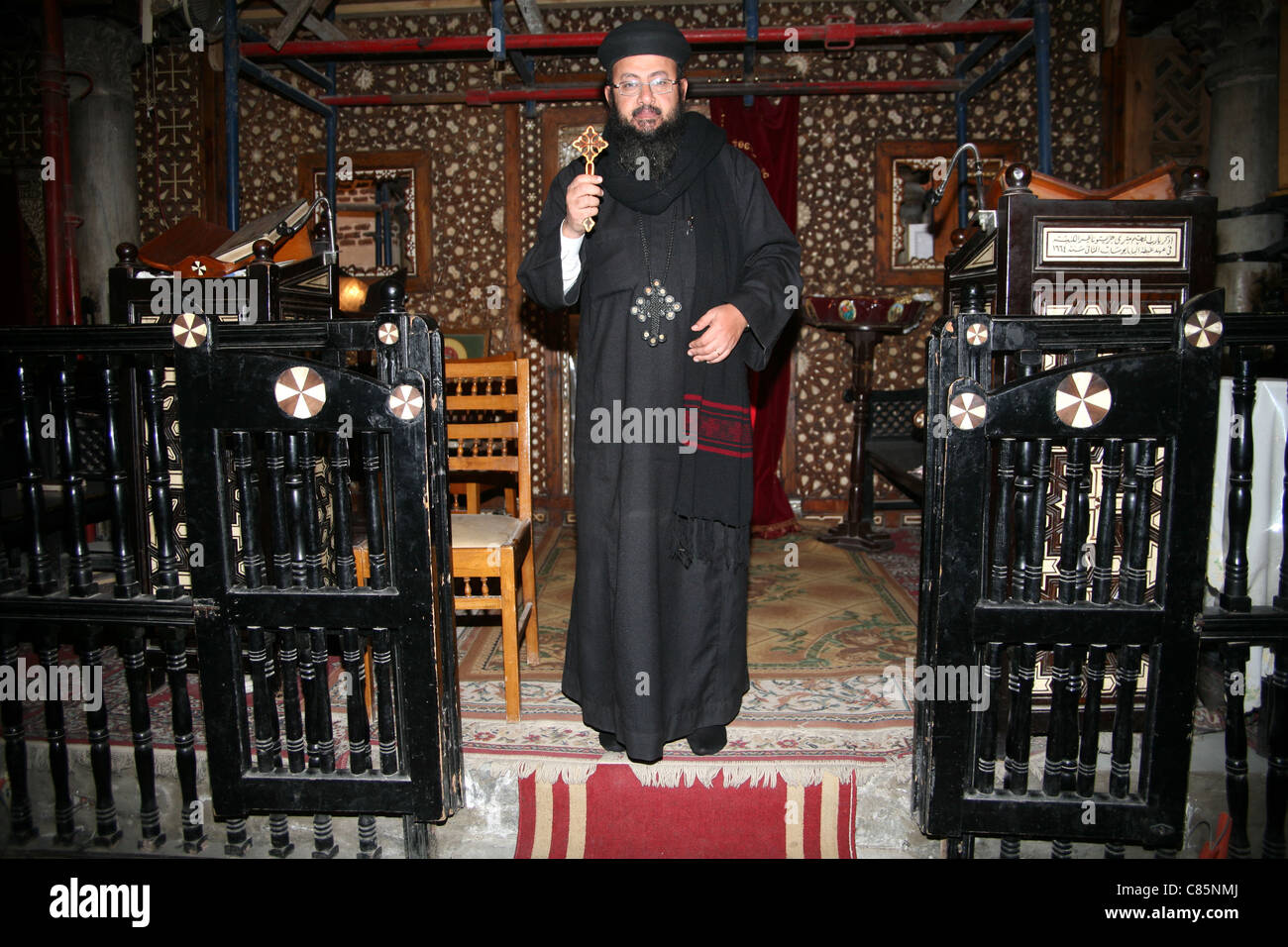 A Coptic Christian priest in the Church of the Holy Virgin at Haret ...