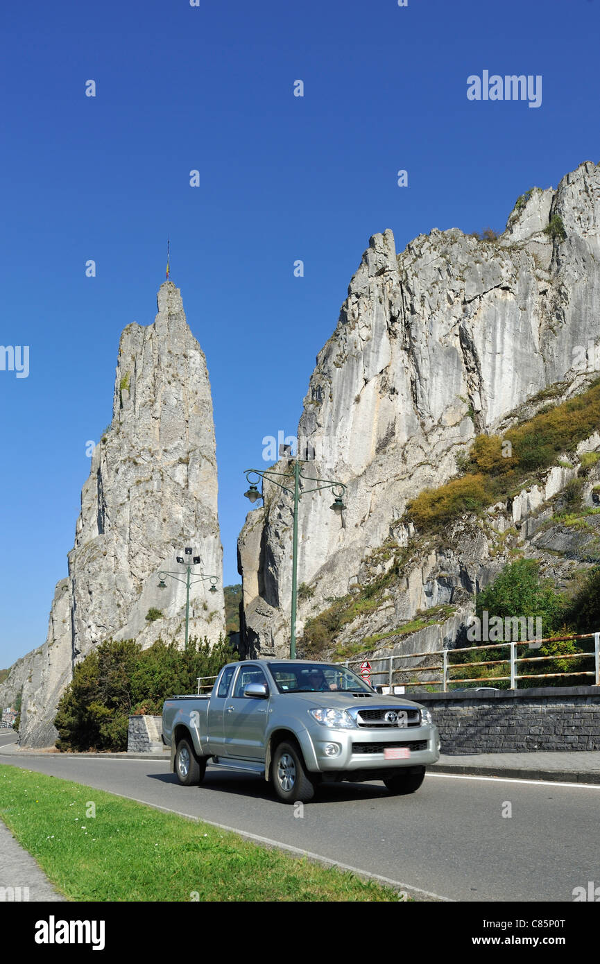 Car driving past the rock formation Rocher Bayard at Dinant along the ...