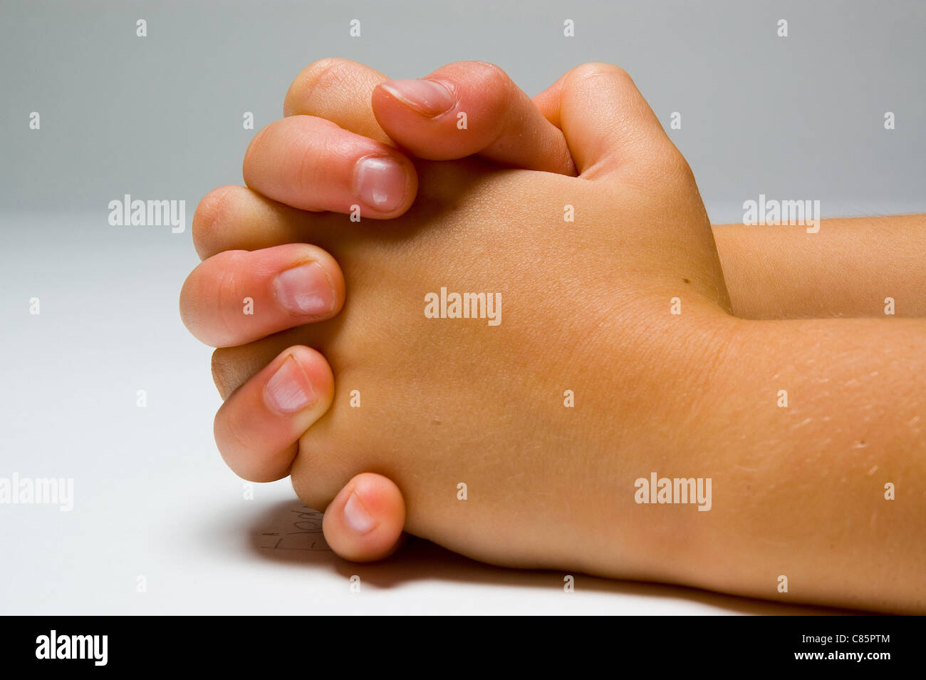 Pair of hands clasped together Stock Photo - Alamy