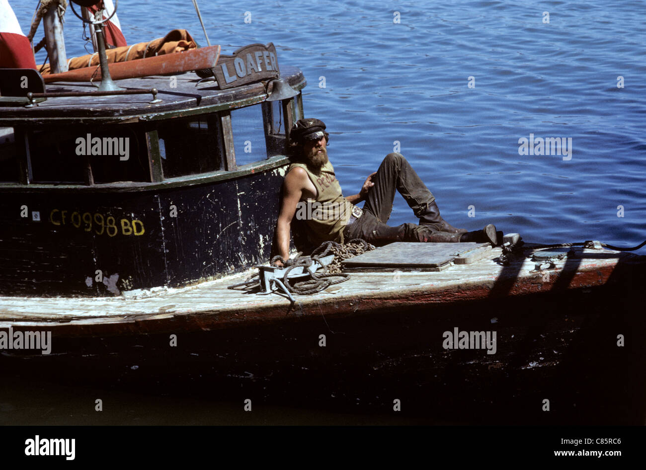 man resting on boat named loafer on San Francisco Bay Stock Photo - Alamy