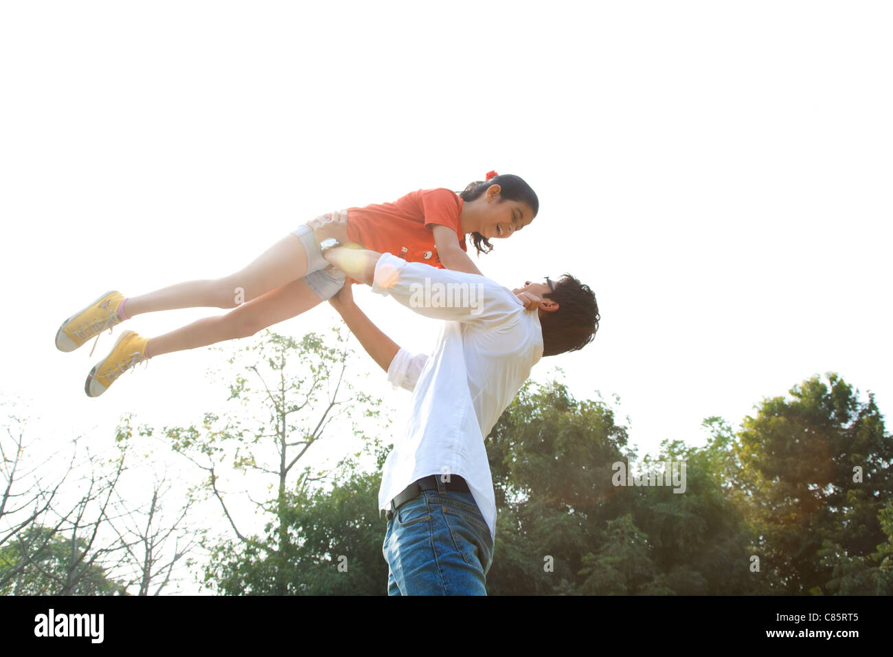 Father lifting his daughter in the air Stock Photo - Alamy