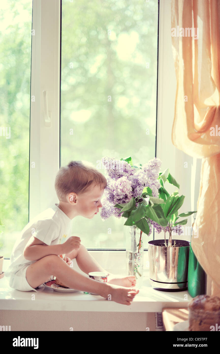 The child sits at a window Stock Photo - Alamy