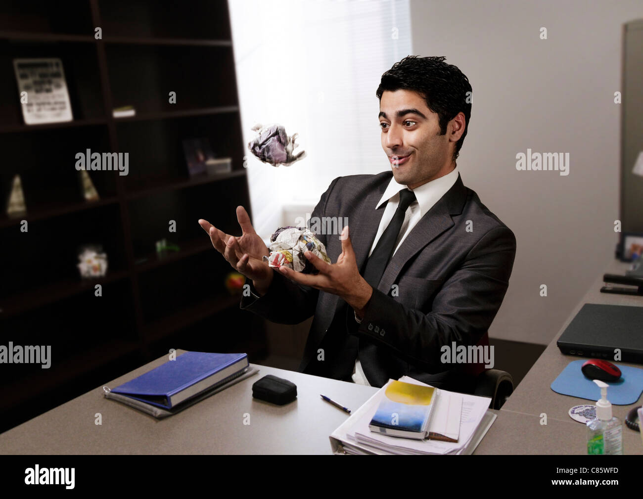 Businessman juggling paper in the office Stock Photo - Alamy