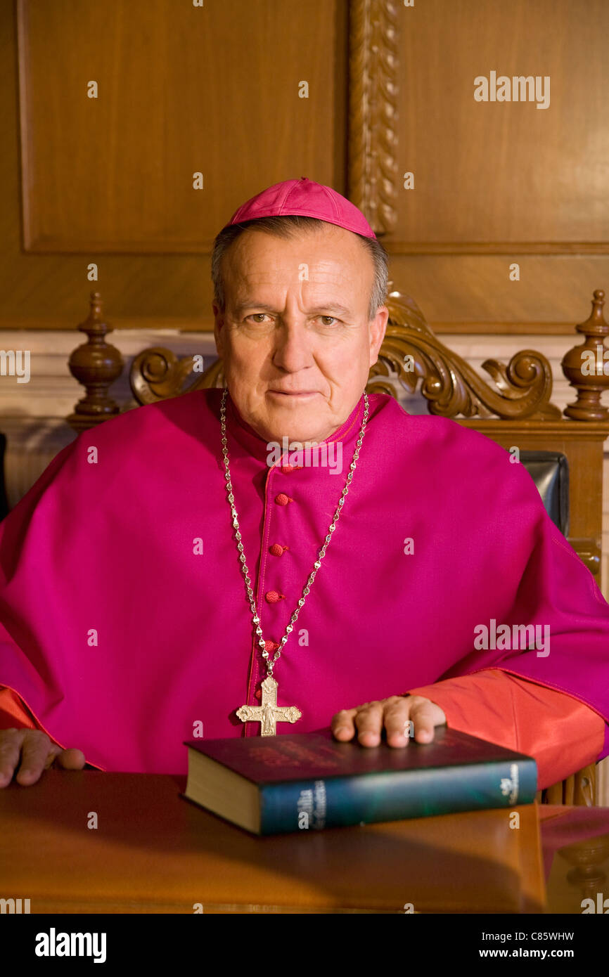 Hispanic bishop sitting with bible Stock Photo - Alamy