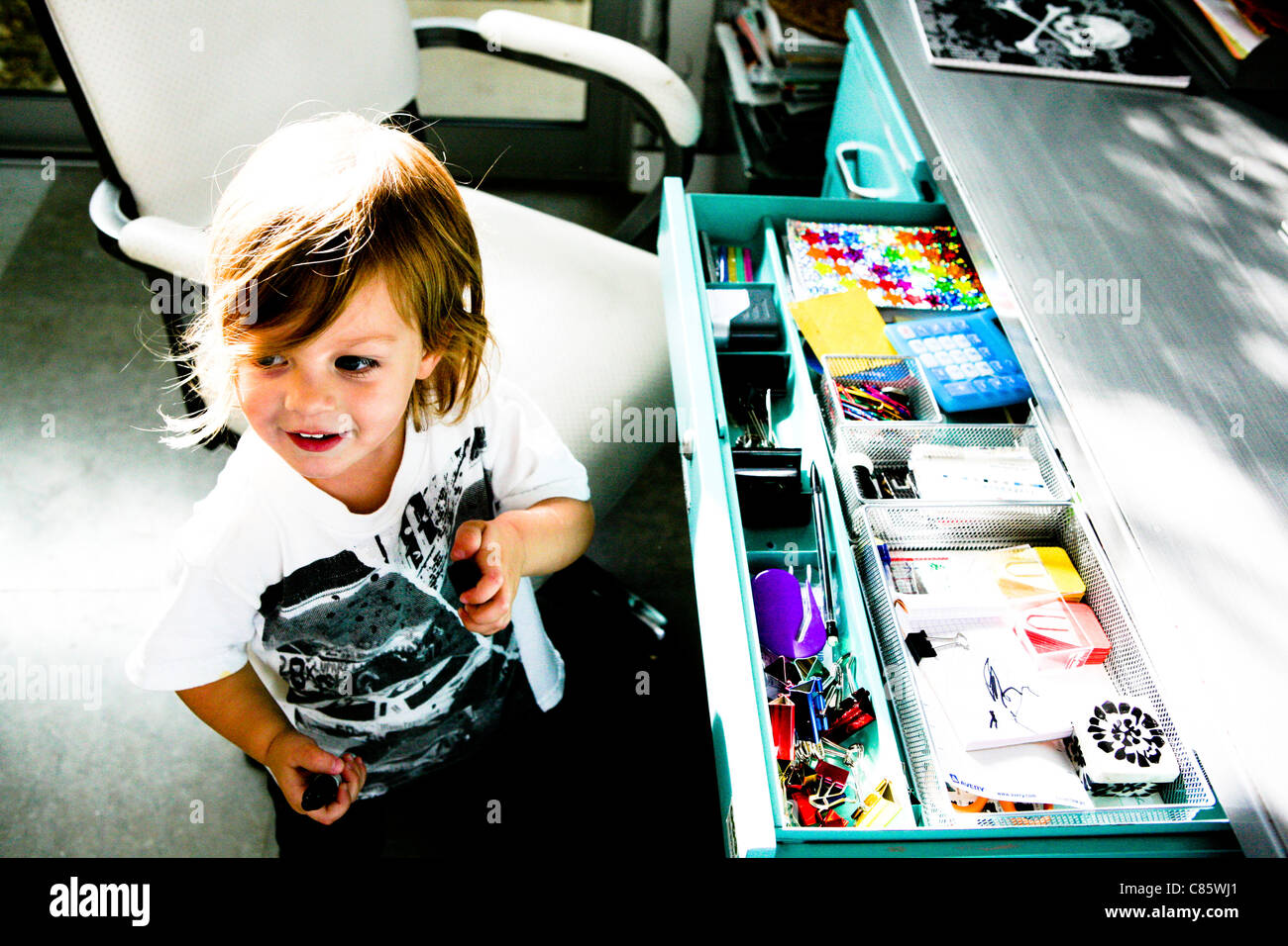 Little boy at large desk Stock Photo - Alamy