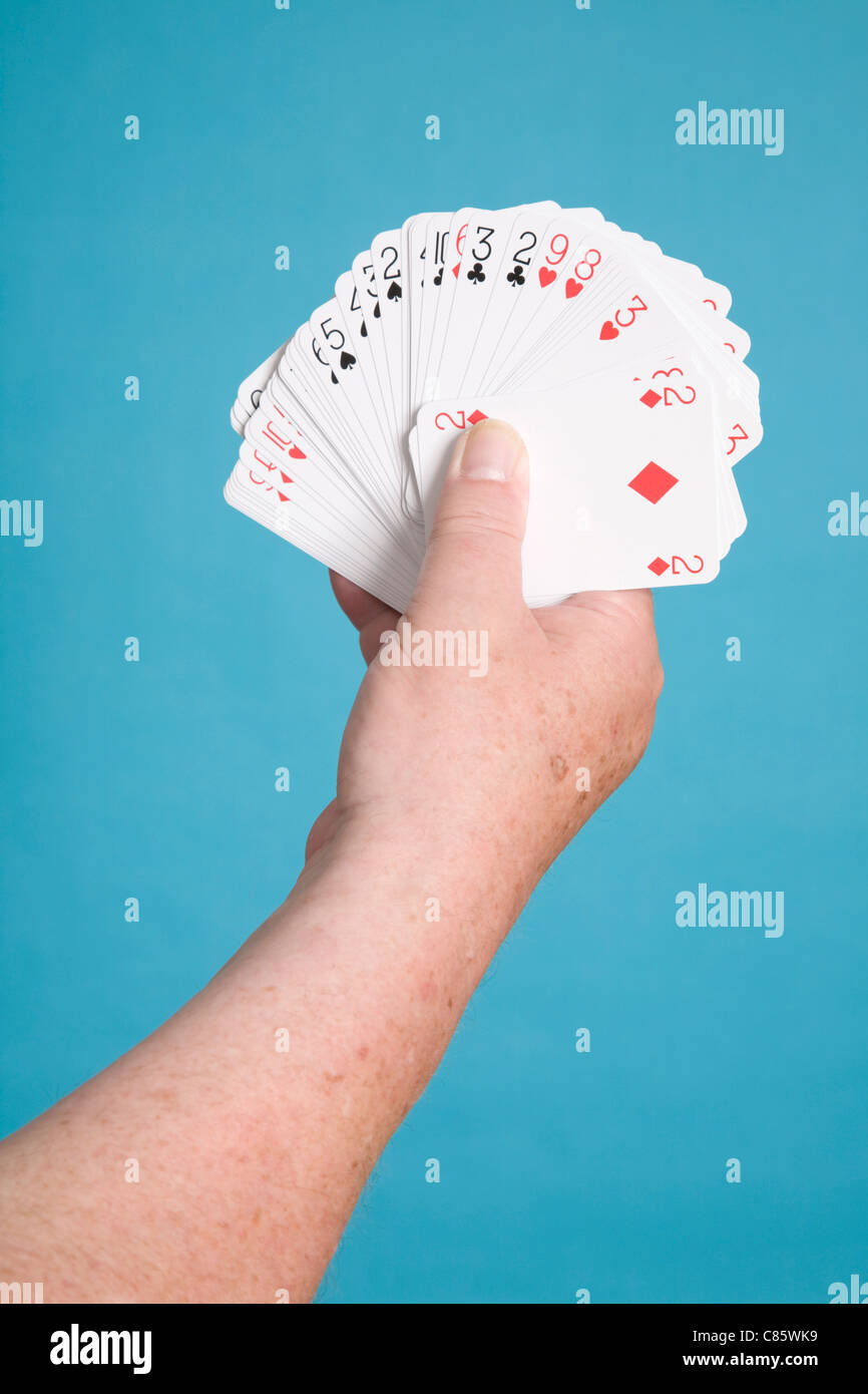 Hand with playing cards Stock Photo - Alamy