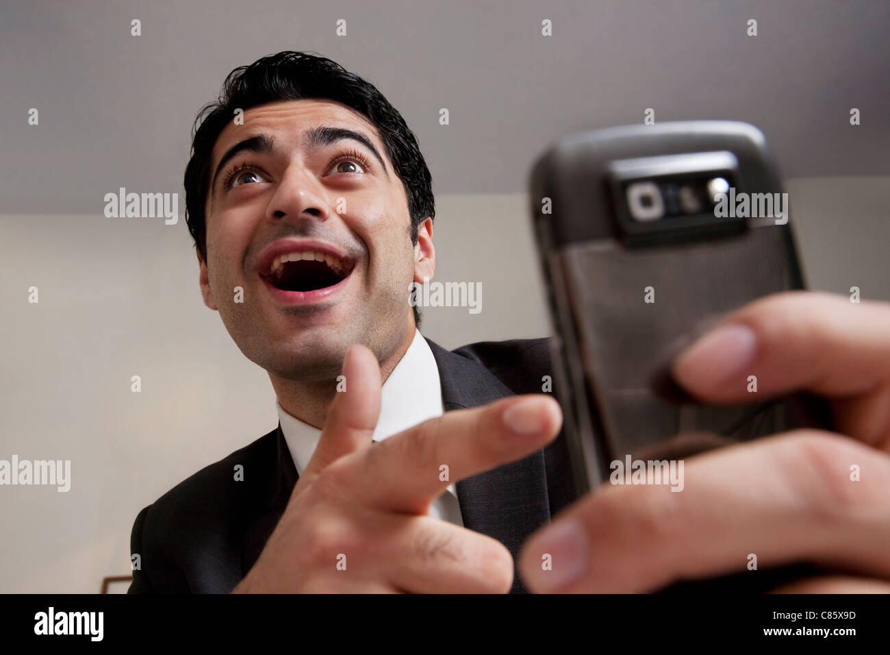 Businessman pointing at his mobile phone Stock Photo - Alamy