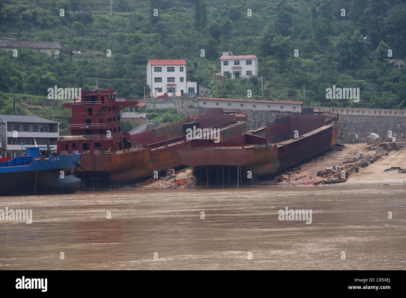 River freighters under construction at a shipyard on the banks of the ...