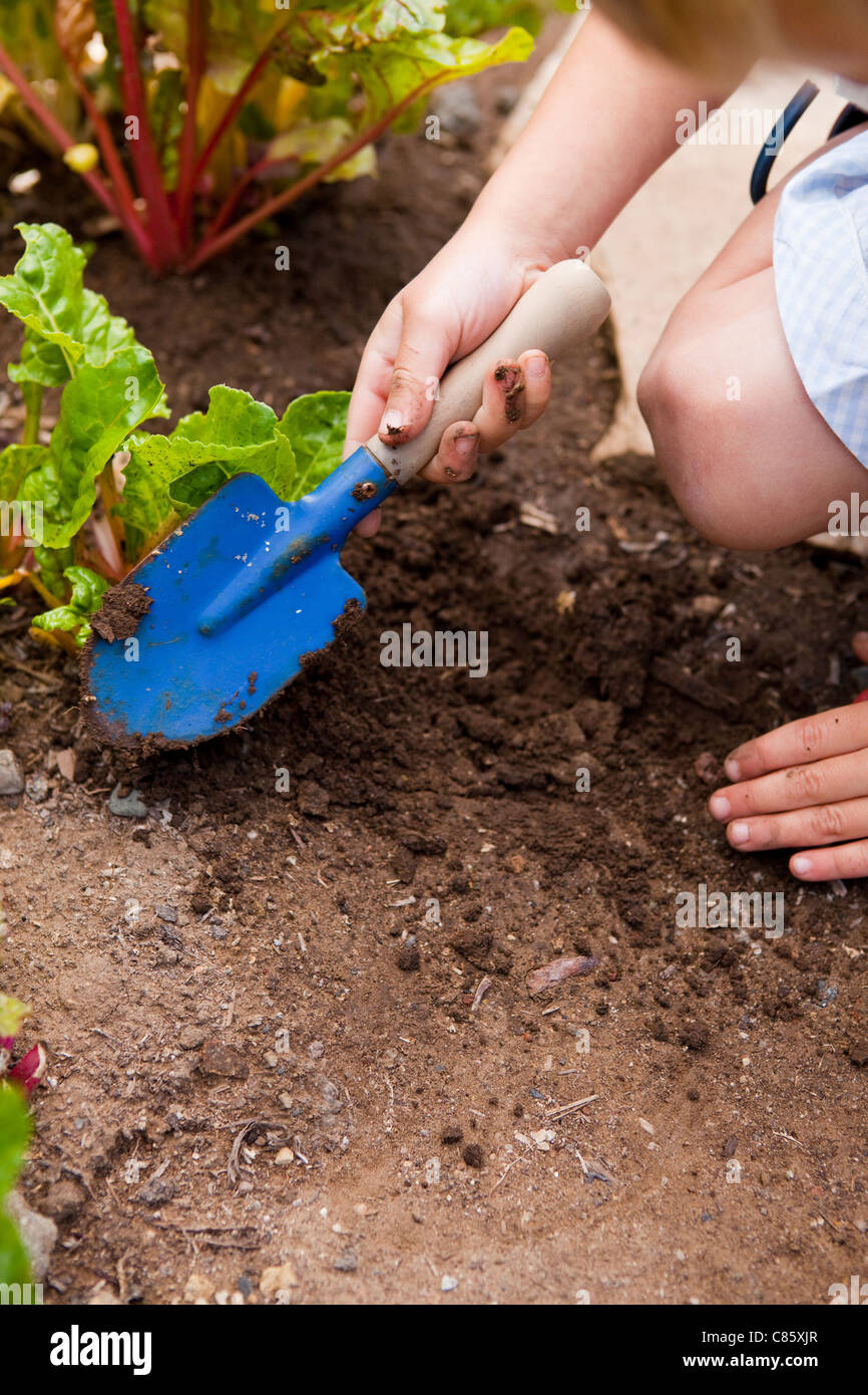Little boy helping in the garden Stock Photo - Alamy